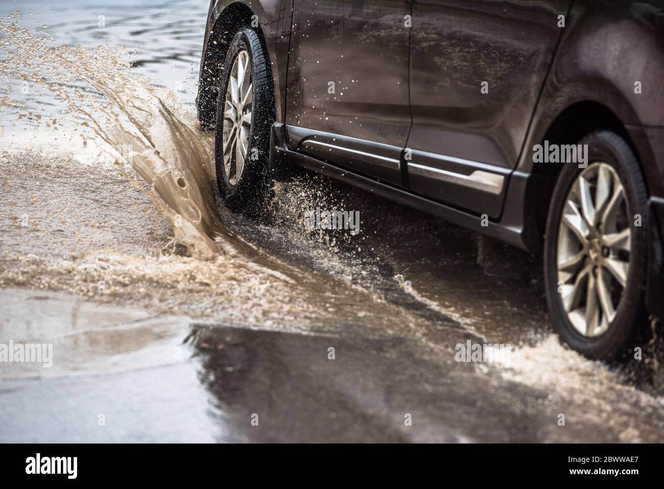 dirty water splash after vehicle roaring by Stock Photo - Alamy