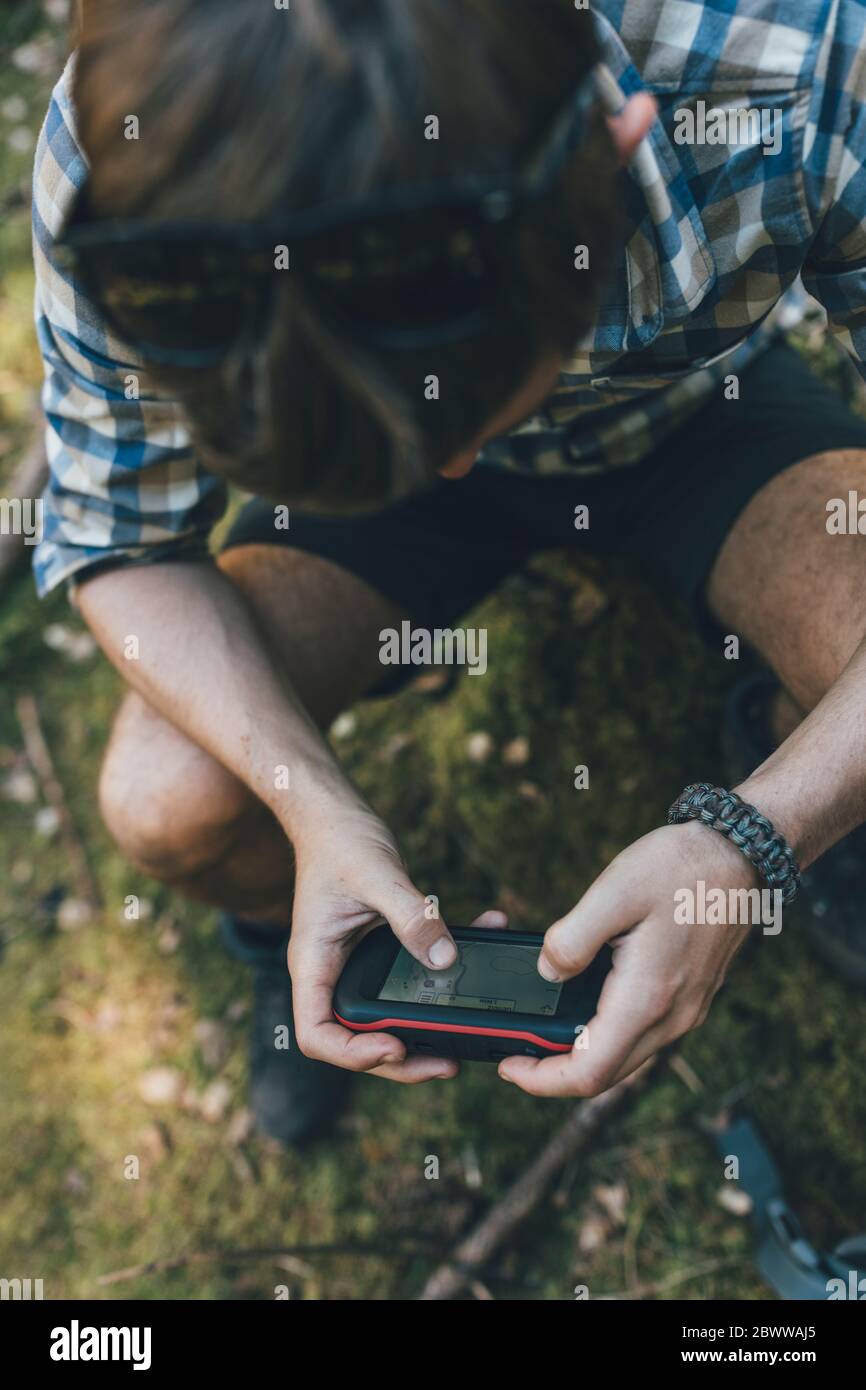 Young man checking navigation device Stock Photo - Alamy