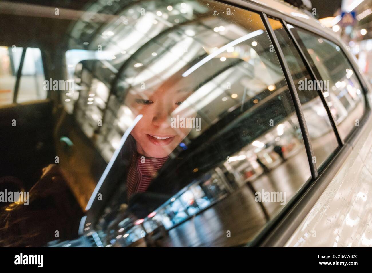 Young woman inside a taxi in the city at night Stock Photo - Alamy