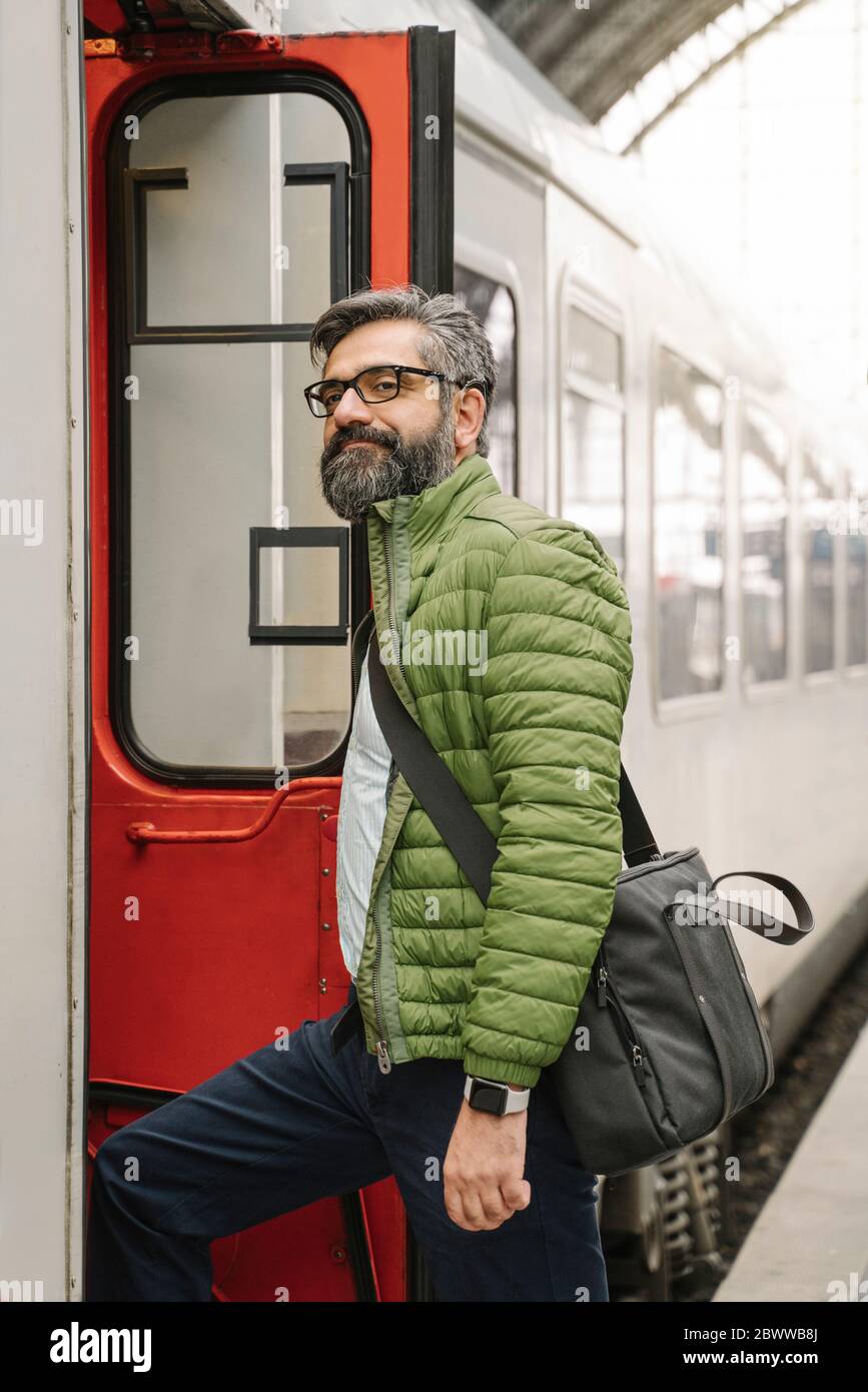 Man getting into a train Stock Photo - Alamy