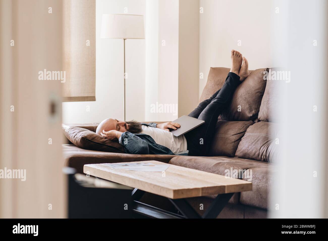 Man feet up sofa hi-res stock photography and images - Alamy
