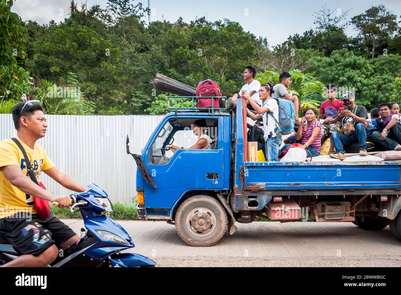 Filipino workers head home at the end of a days work in Coron Town ...