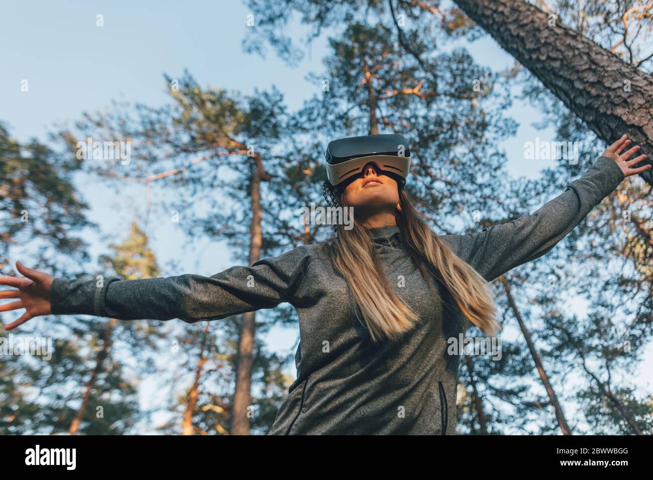 Young woman using vr goggles nature hi-res stock photography and images ...