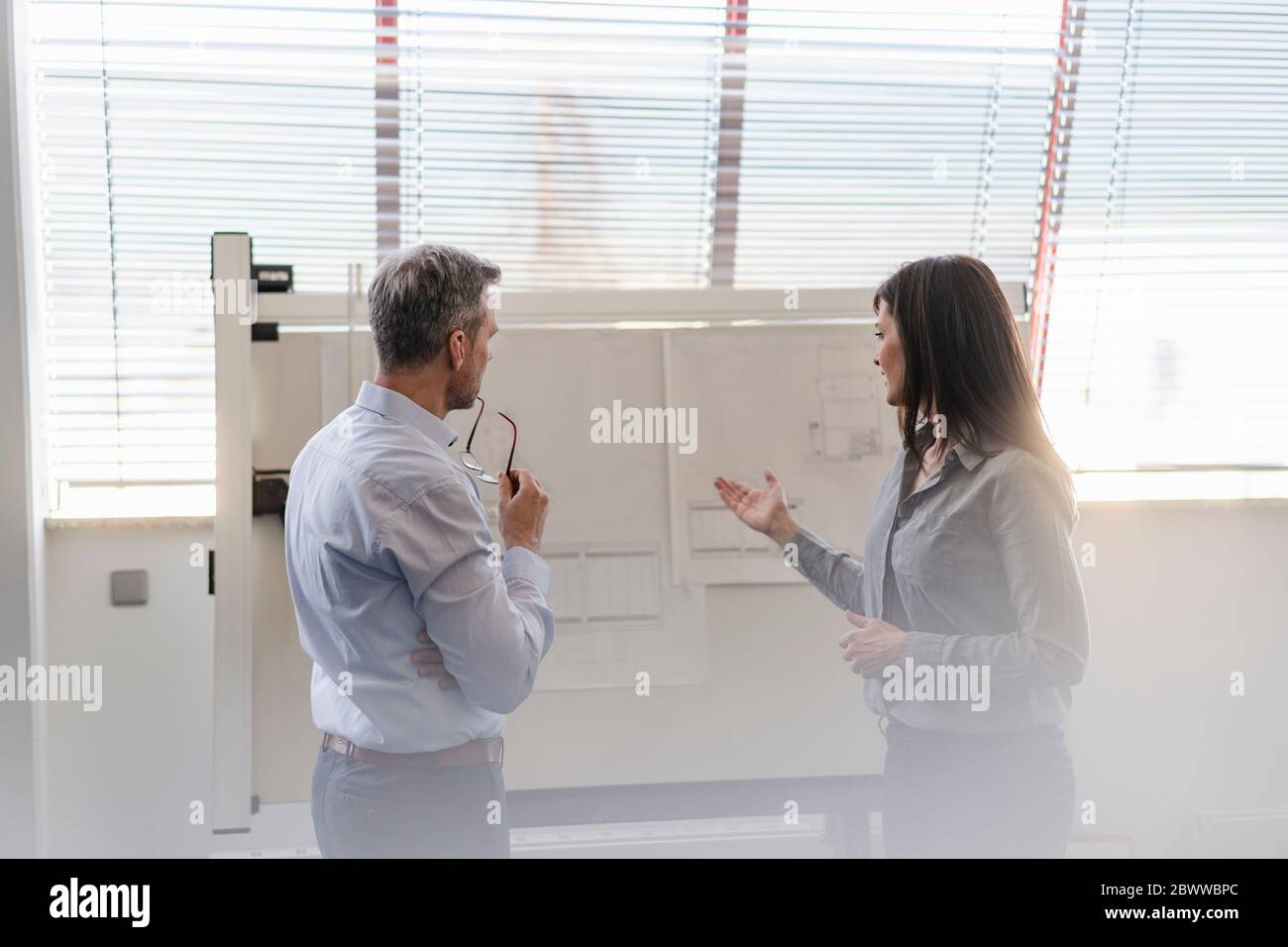 Businessman and businesswoman having a meeting in office Stock Photo ...
