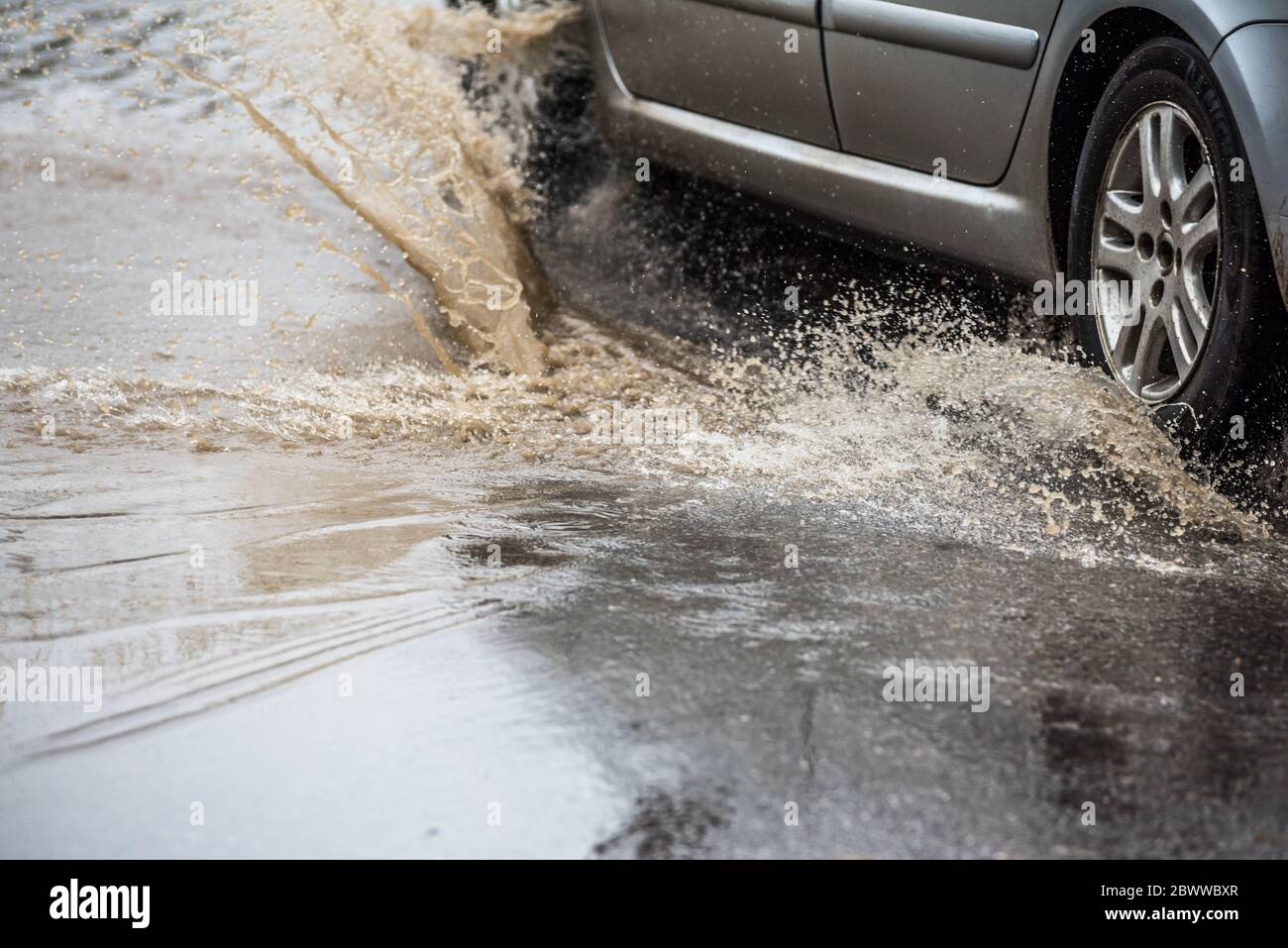 dirty water splash after vehicle roaring by Stock Photo - Alamy