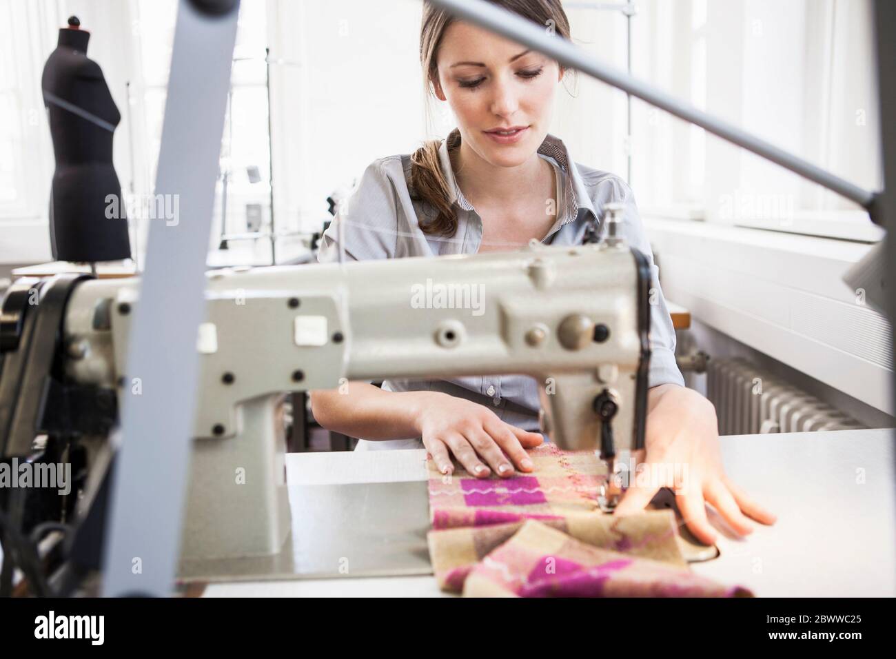 Seamstress at work in a tailor shop Stock Photo - Alamy