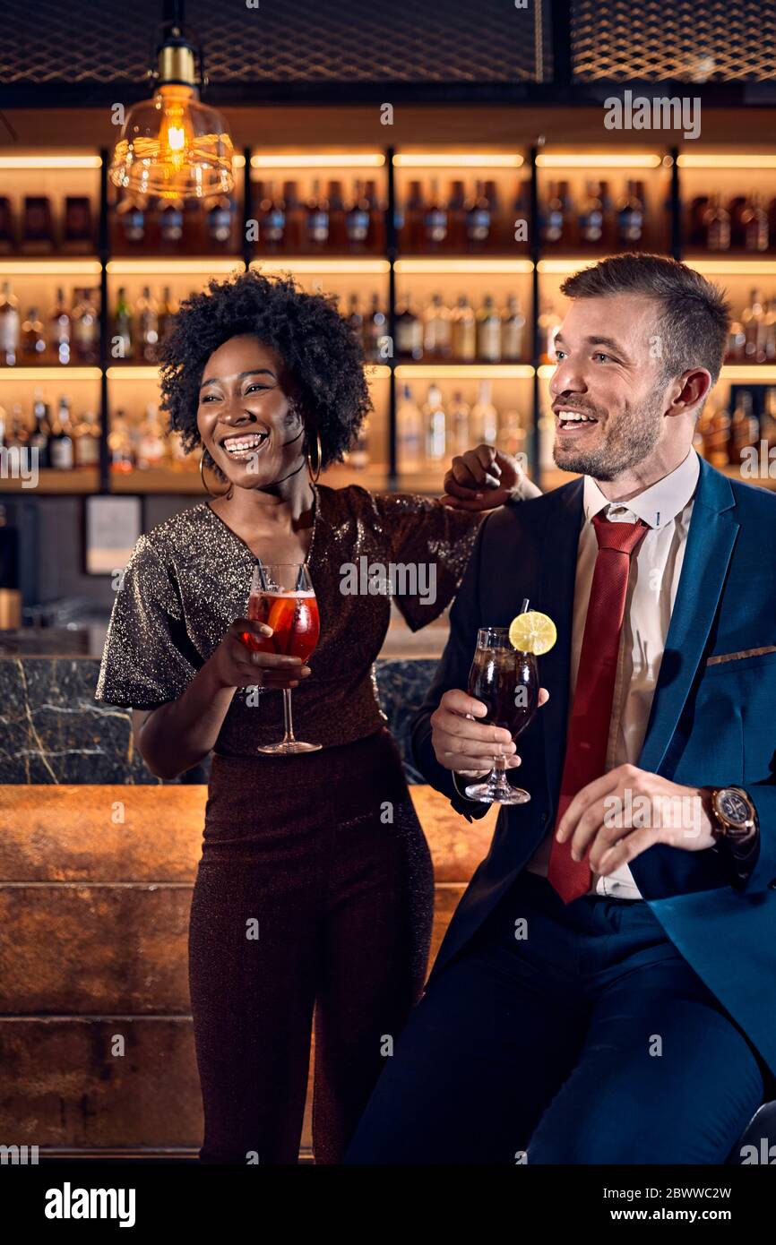 Cheerful couple socializing in a bar Stock Photo - Alamy