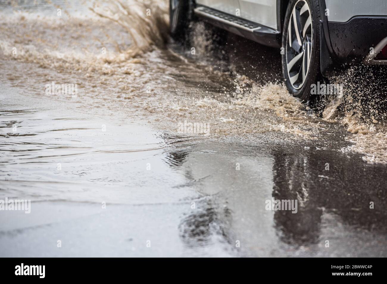 dirty water splash after vehicle roaring by Stock Photo - Alamy