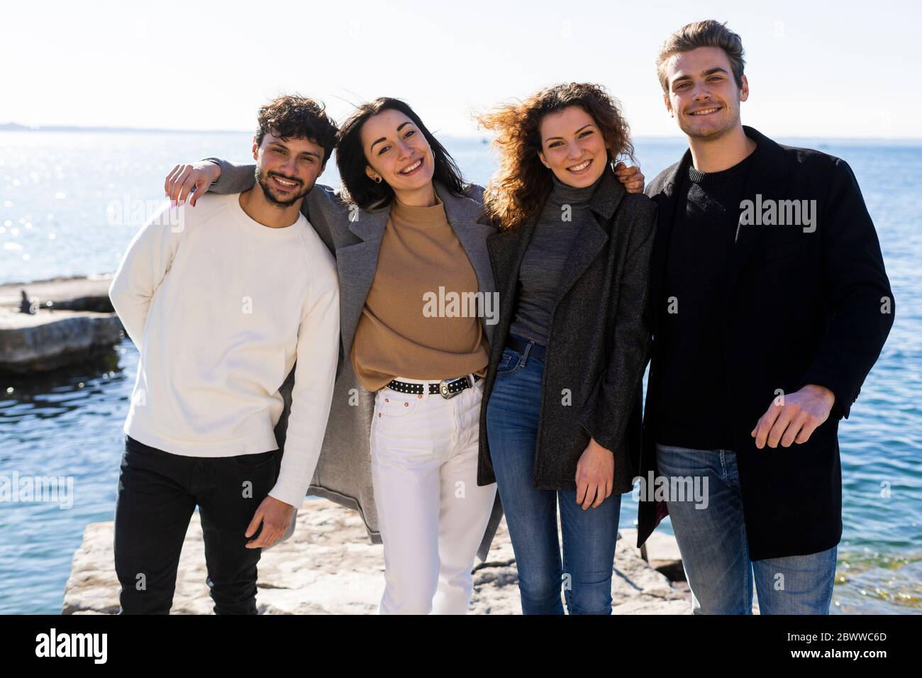 Portrait of four friends standing at Lake Garda, Italy Stock Photo - Alamy