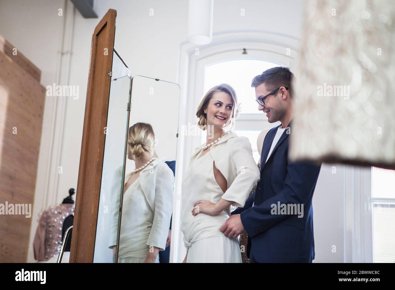 Wedding dress designer fitting customer hi-res stock photography and ...
