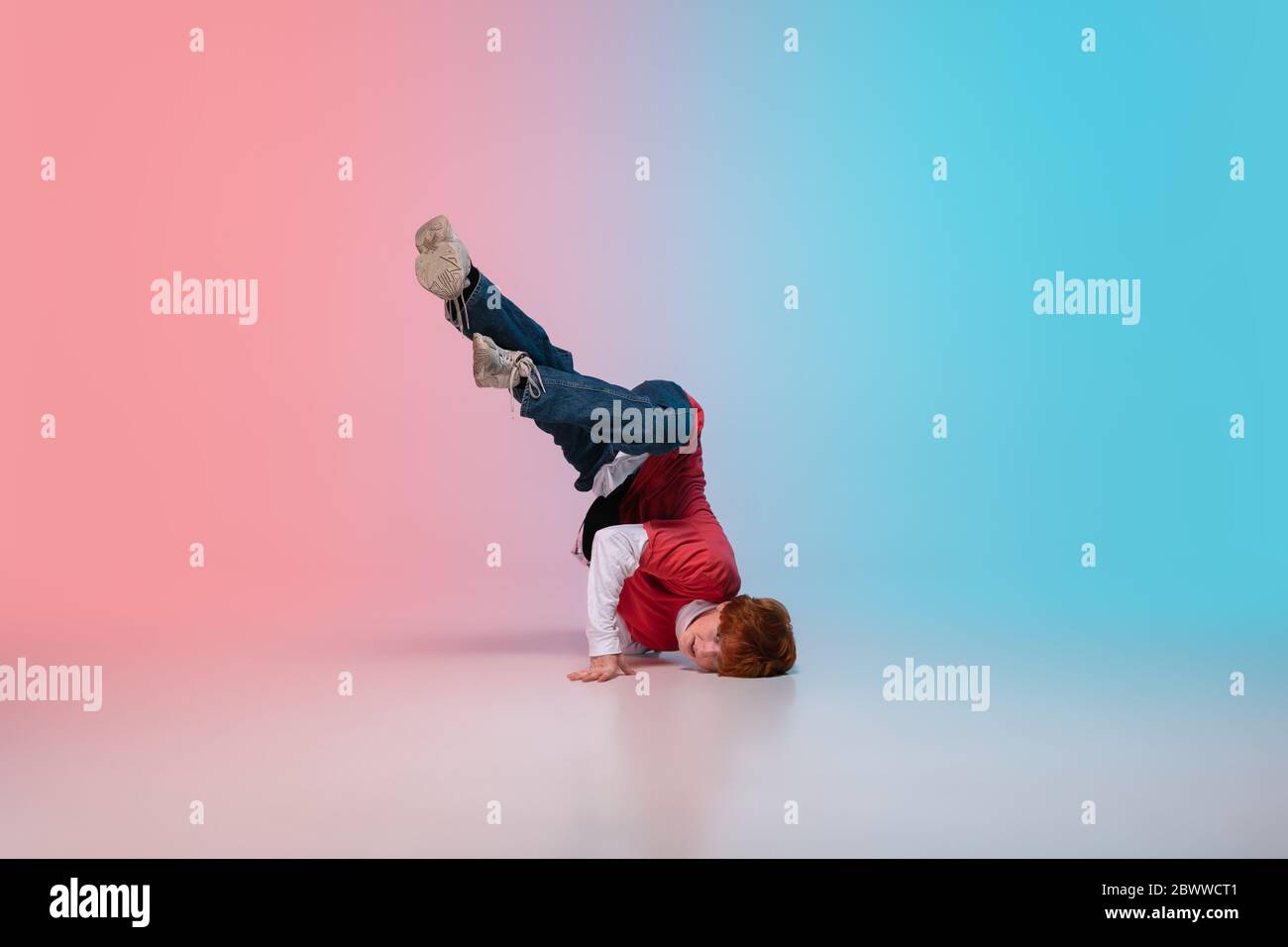 Beautiful sportive boy dancing hip-hop in stylish clothes on colorful ...