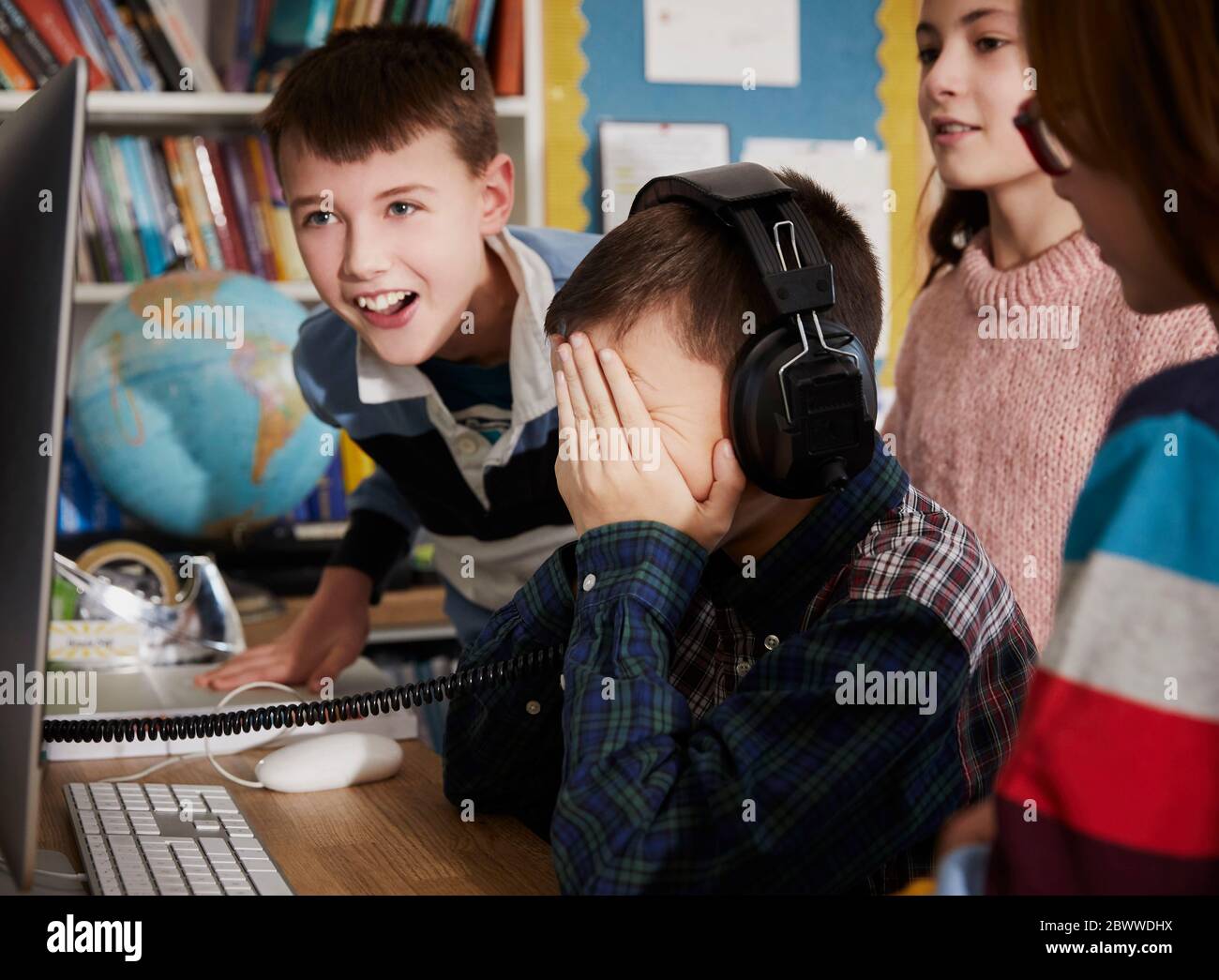 Boy laughing in a classroom hi-res stock photography and images - Alamy
