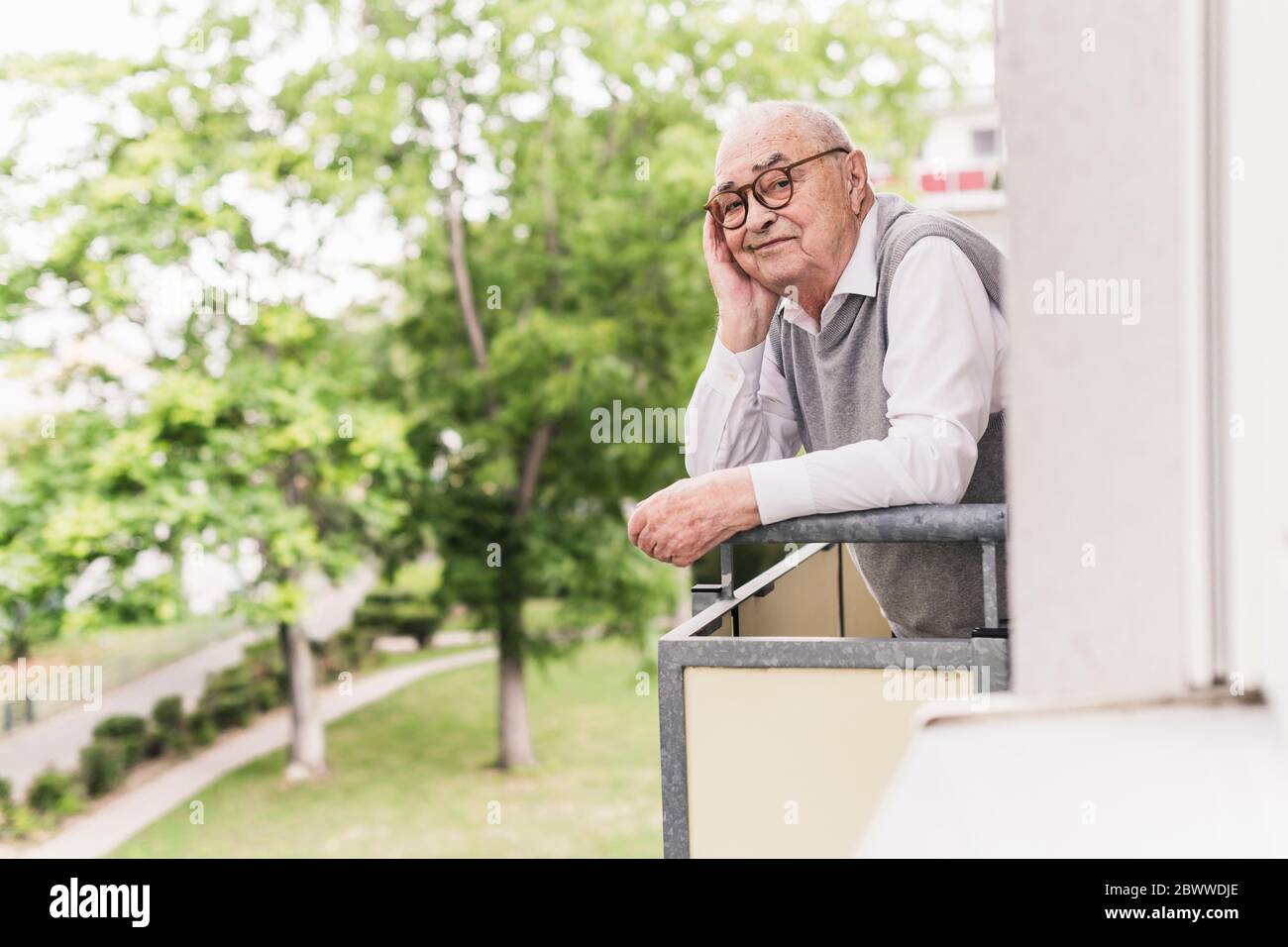 Standing looking out balcony hi-res stock photography and images - Alamy
