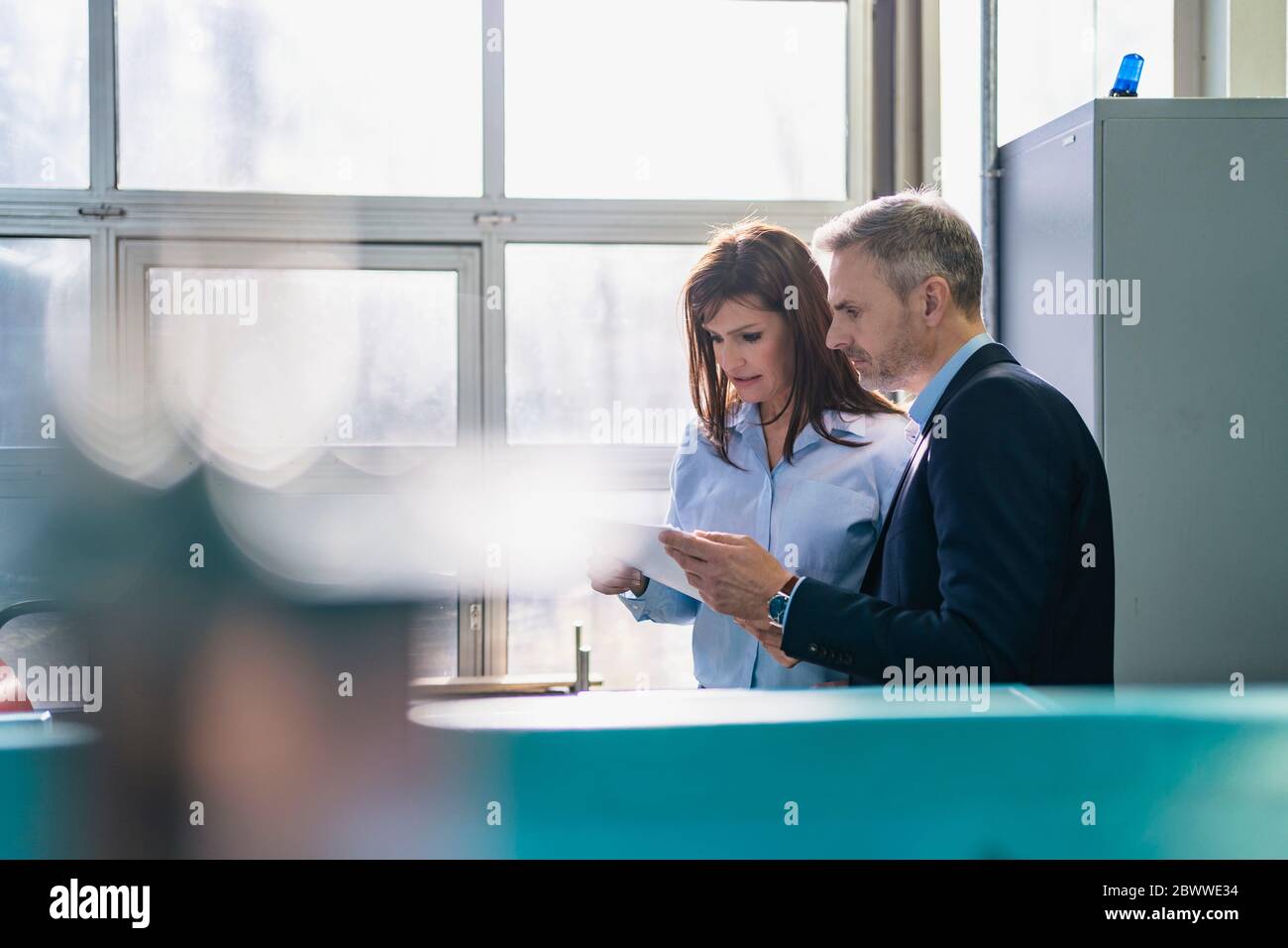 Businessman and businesswoman having a work meeting in a factory Stock ...