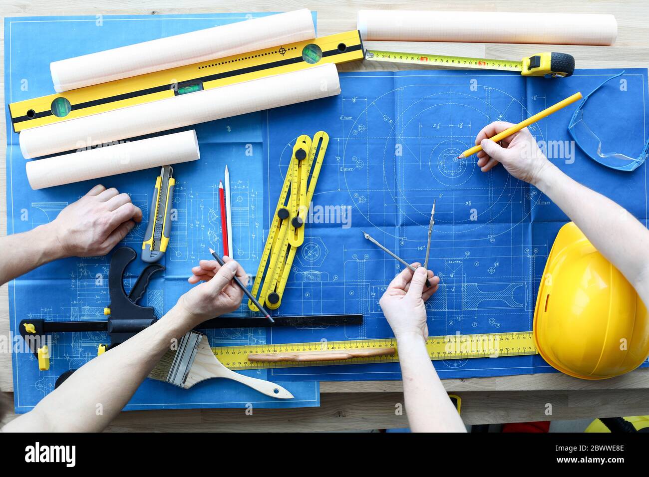 Men draftsmen on table draw construction project Stock Photo - Alamy
