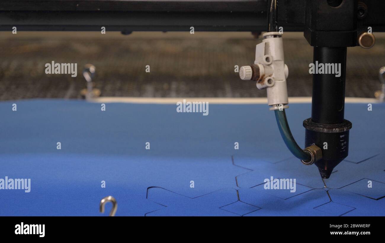 Industrial garment factory, an automatic sewing machine sews various ...