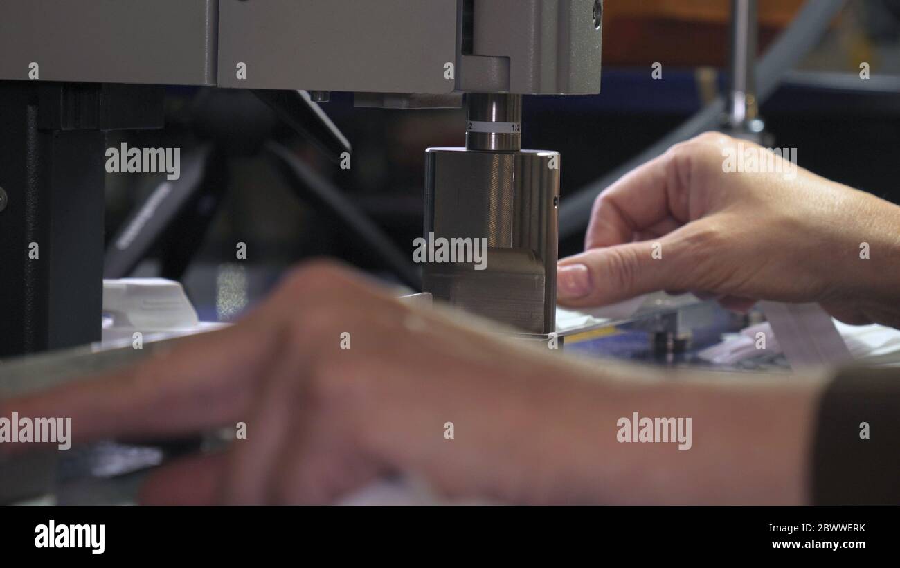 Industrial garment factory, an automatic sewing machine sews various ...