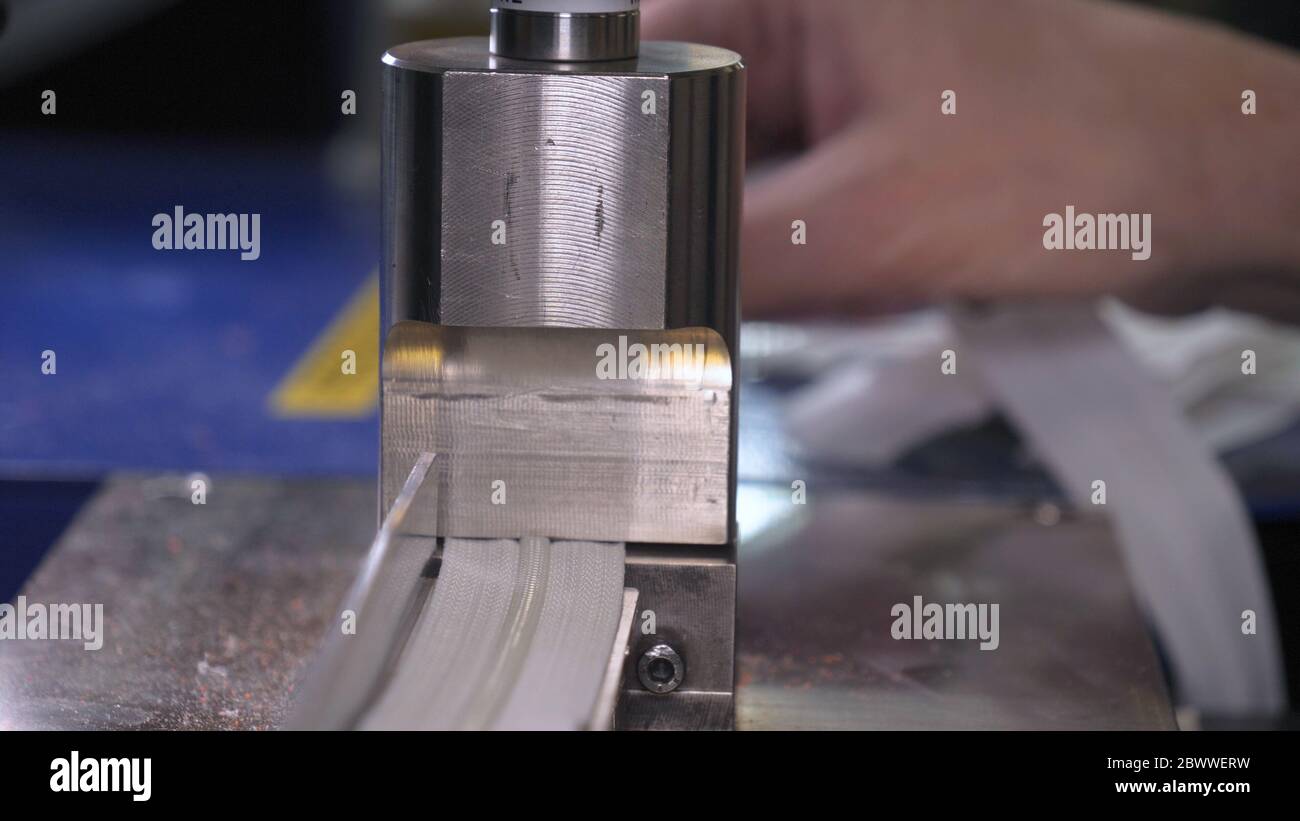 Industrial garment factory, an automatic sewing machine sews various ...