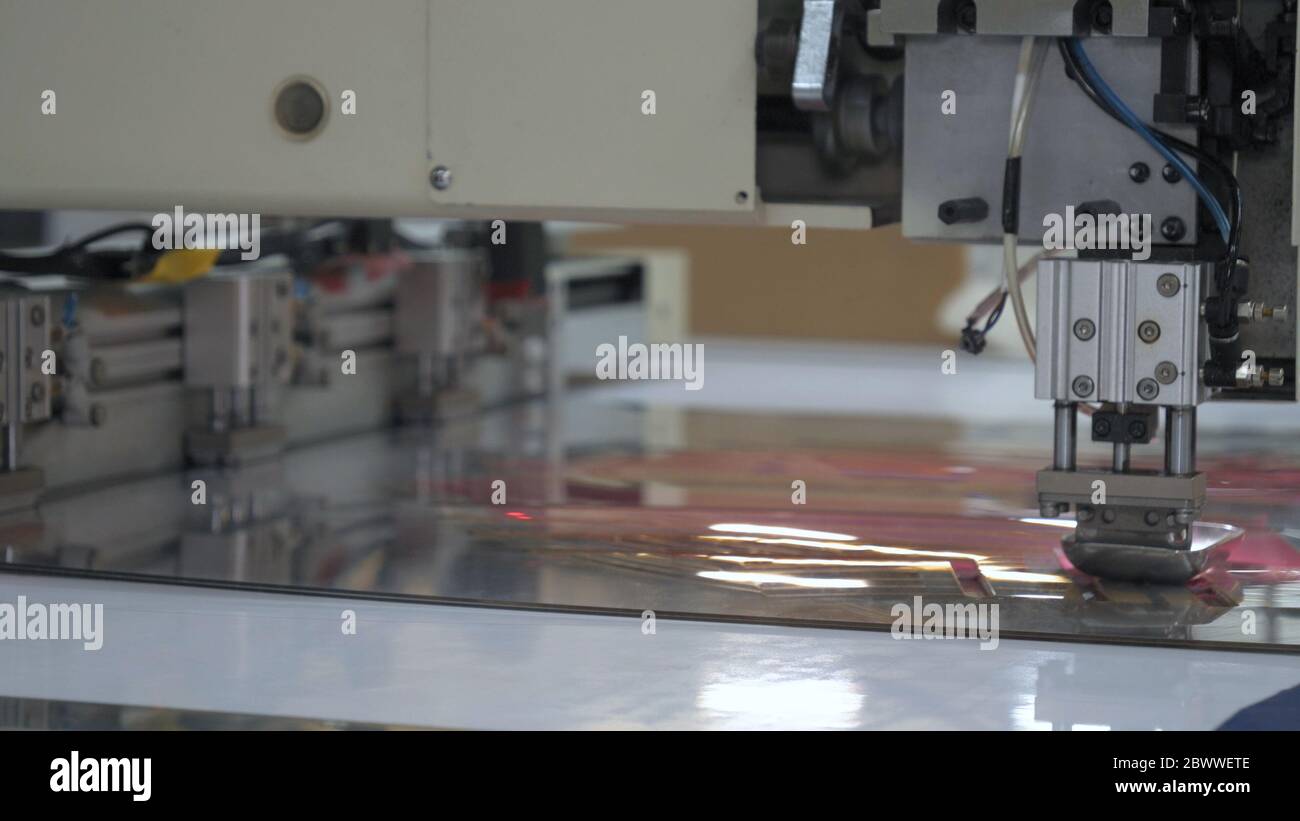 Industrial garment factory, an automatic sewing machine sews various ...