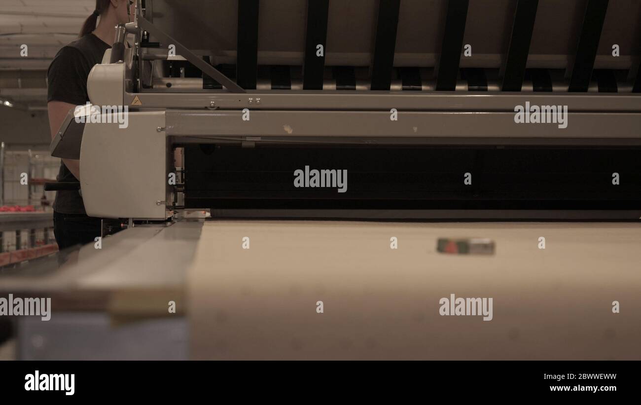 Industrial garment factory, an automatic sewing machine sews various ...