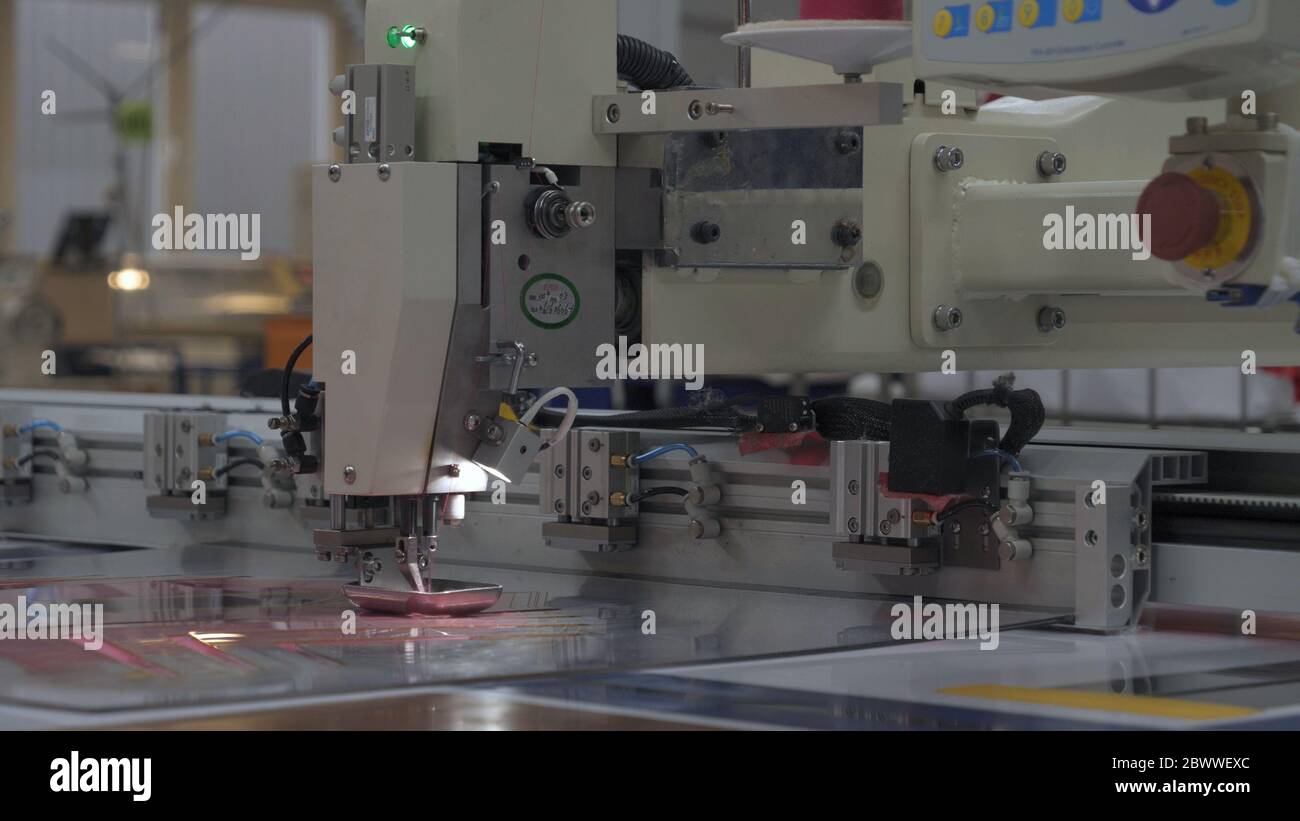 Industrial garment factory, an automatic sewing machine sews various ...