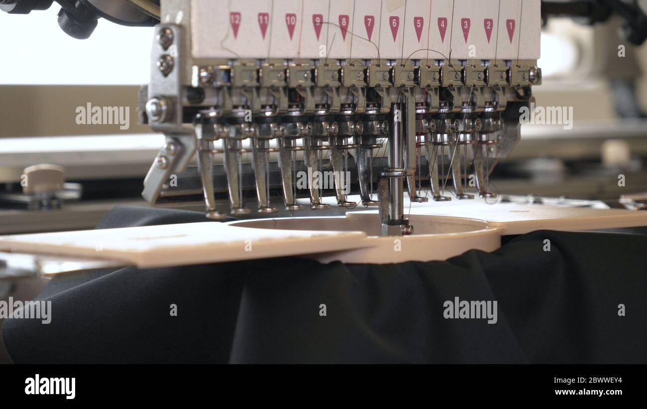Industrial garment factory, an automatic sewing machine sews various ...