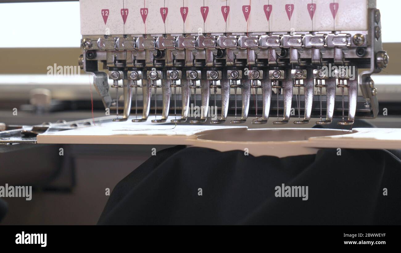 Industrial garment factory, an automatic sewing machine sews various ...