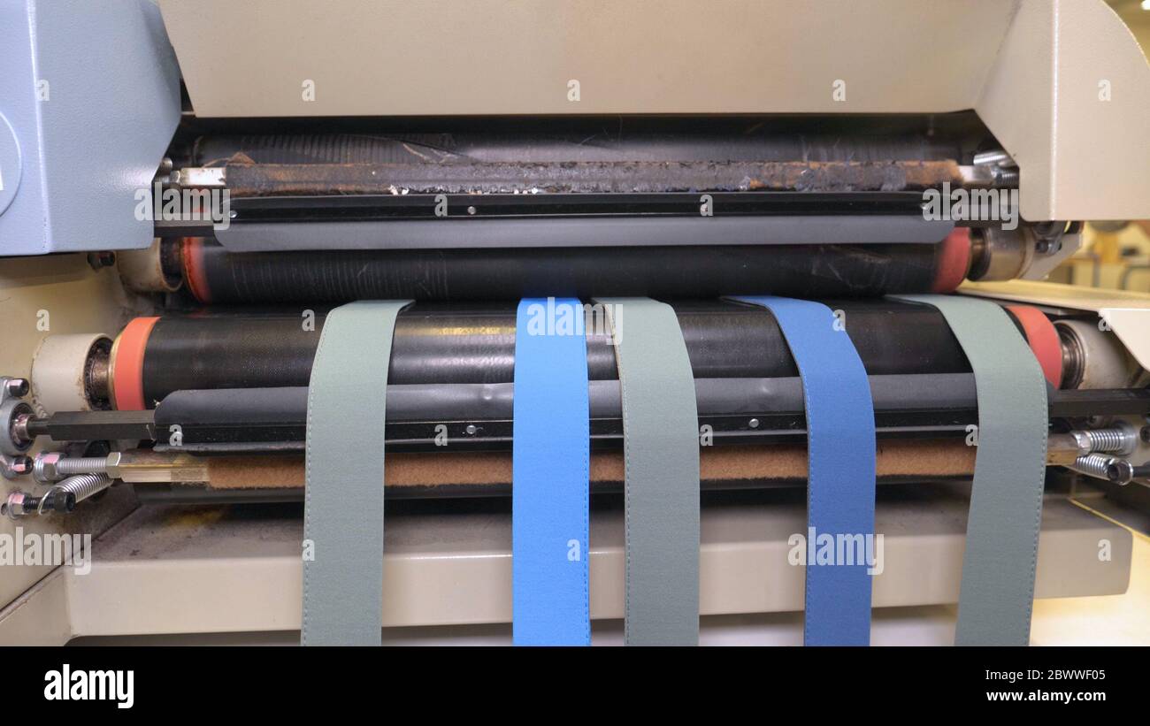 Industrial garment factory, an automatic sewing machine sews various ...