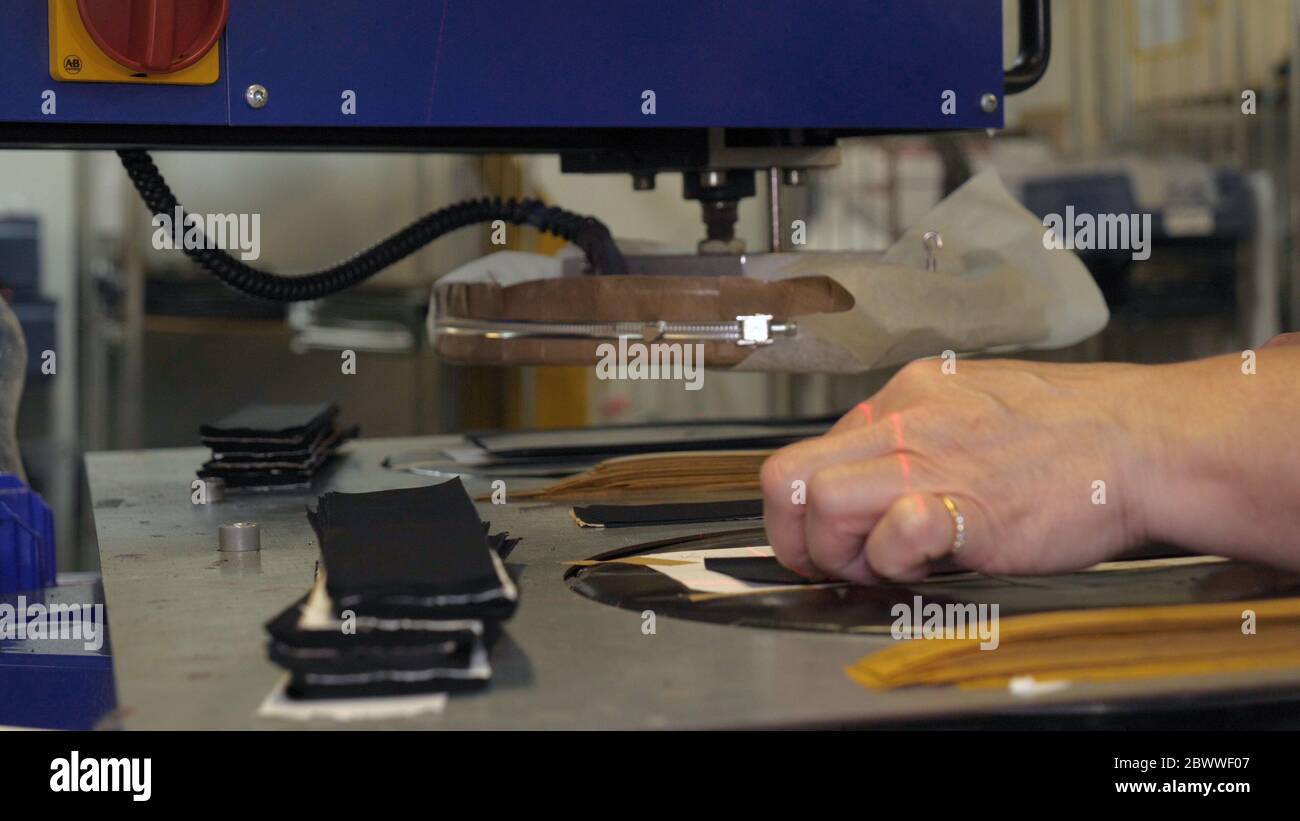 Industrial garment factory, an automatic sewing machine sews various ...