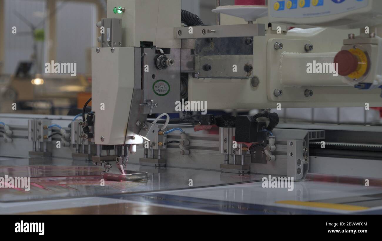 Industrial garment factory, an automatic sewing machine sews various ...