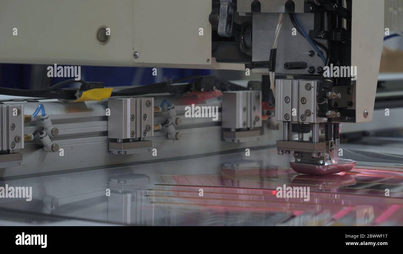 Industrial garment factory, an automatic sewing machine sews various ...