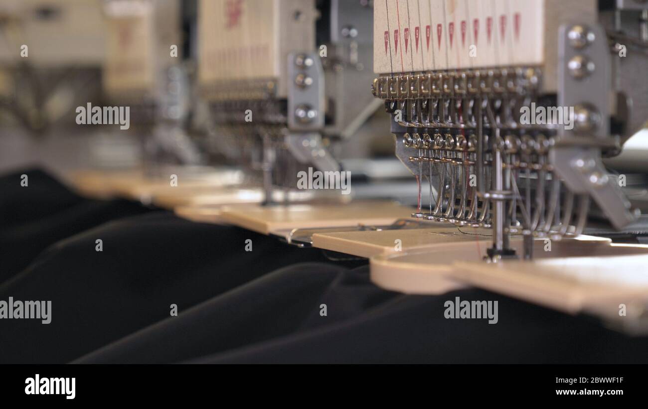 Industrial garment factory, an automatic sewing machine sews various ...