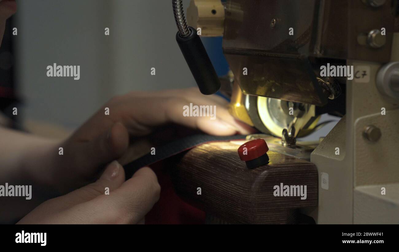 Industrial garment factory, an automatic sewing machine sews various ...