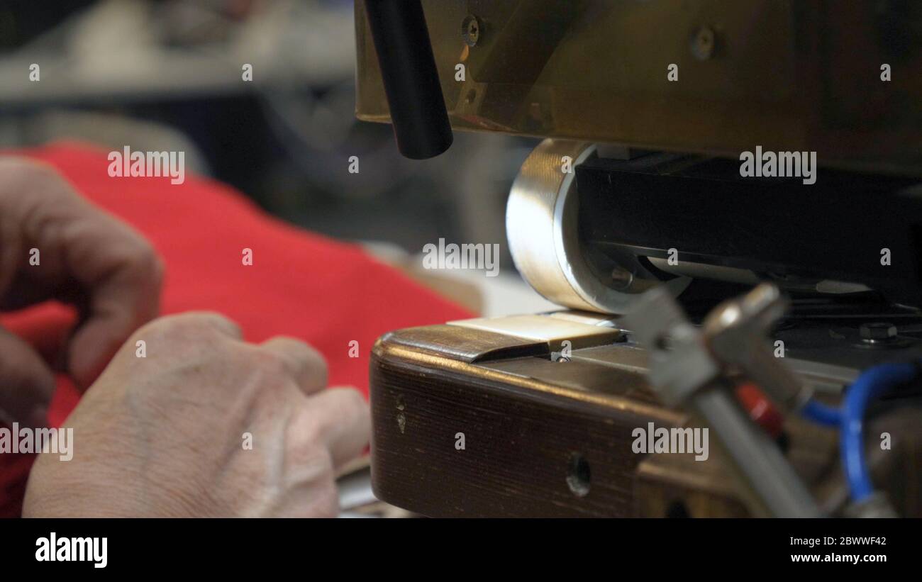 Industrial garment factory, an automatic sewing machine sews various ...