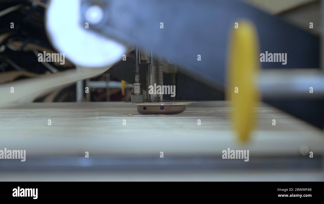 Industrial garment factory, an automatic sewing machine sews various ...