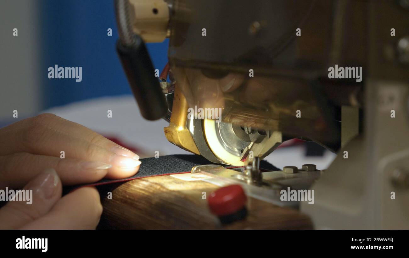 Industrial garment factory, an automatic sewing machine sews various ...