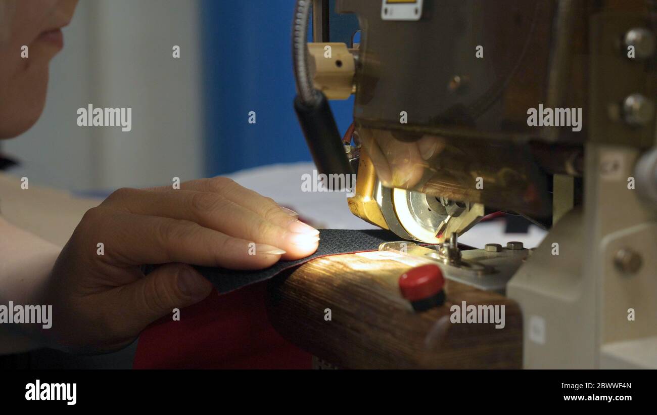 Industrial garment factory, an automatic sewing machine sews various ...