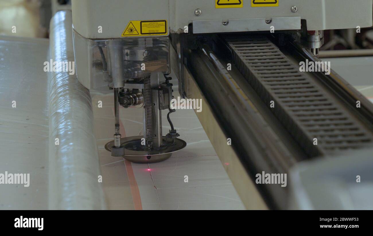 Industrial garment factory, an automatic sewing machine sews various ...