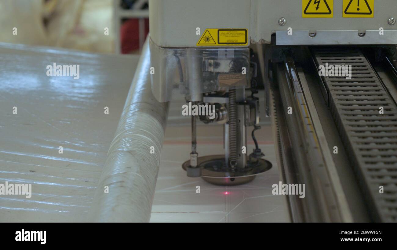 Industrial garment factory, an automatic sewing machine sews various ...