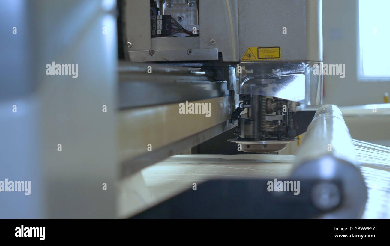 Industrial garment factory, an automatic sewing machine sews various ...