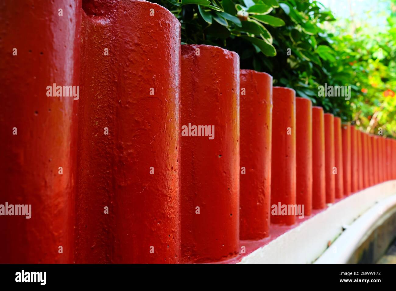Red Concrete Fence in the Garden Stock Photo - Alamy