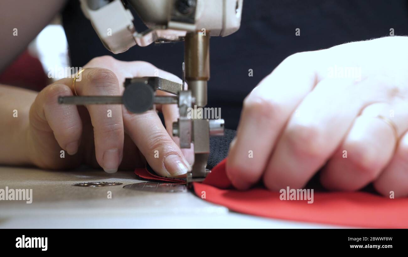 Industrial garment factory, an automatic sewing machine sews various ...