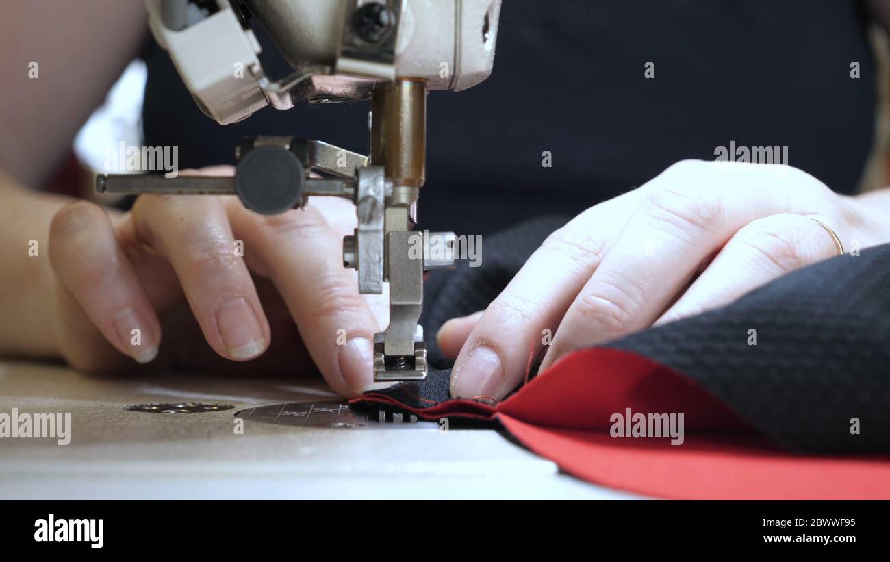 Industrial garment factory, an automatic sewing machine sews various ...