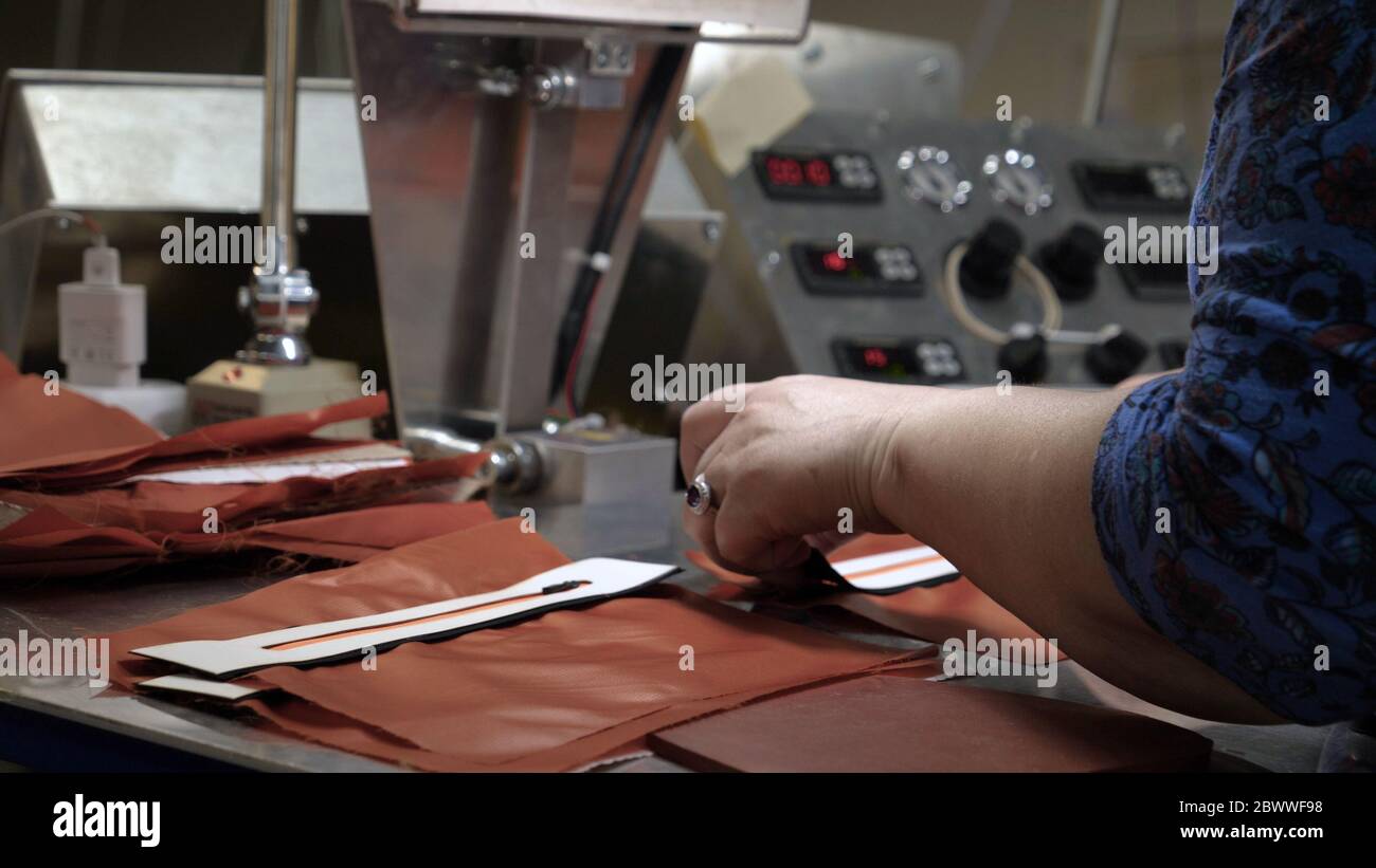 Industrial garment factory, an automatic sewing machine sews various ...