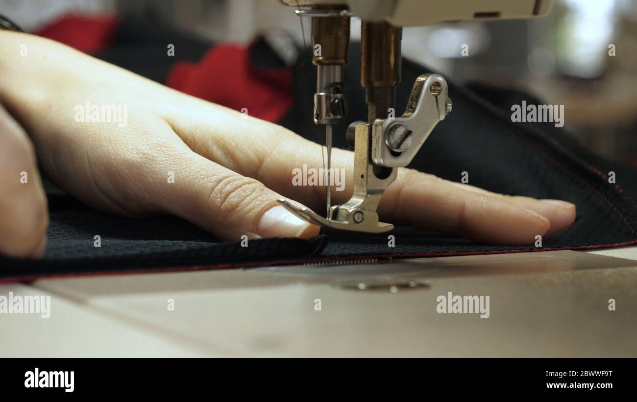 Industrial garment factory, an automatic sewing machine sews various ...