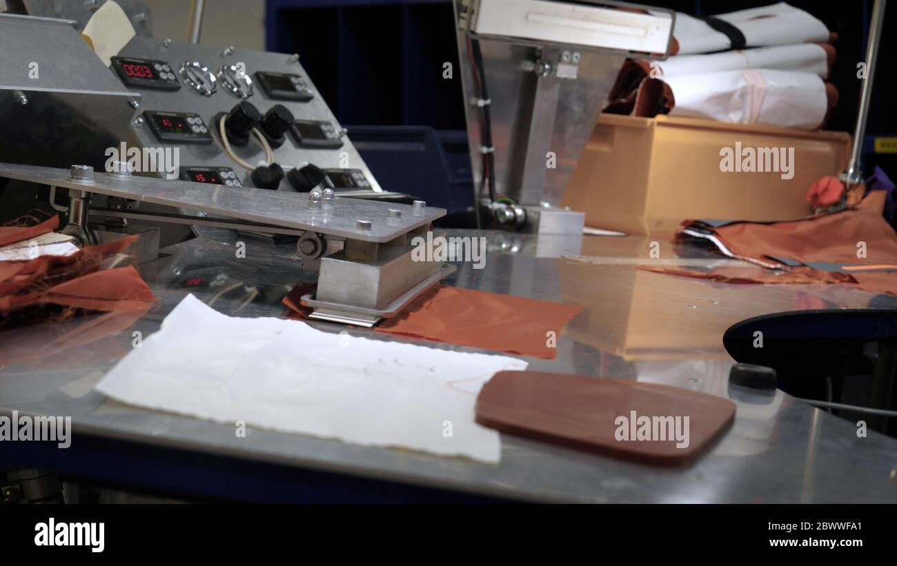 Industrial garment factory, an automatic sewing machine sews various ...