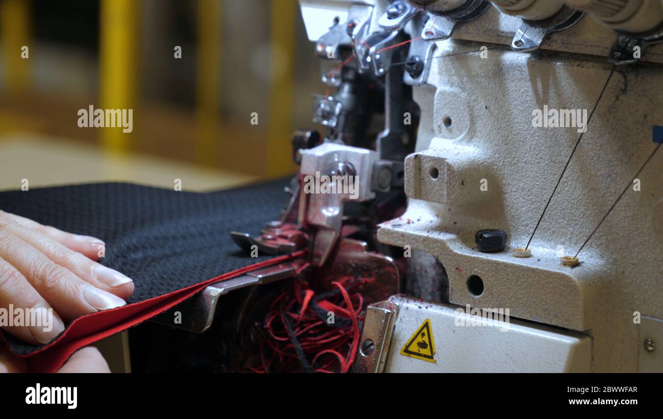 Industrial garment factory, an automatic sewing machine sews various ...