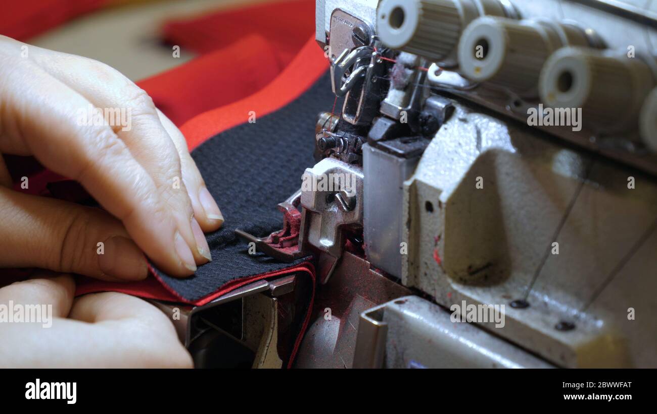 Industrial garment factory, an automatic sewing machine sews various ...