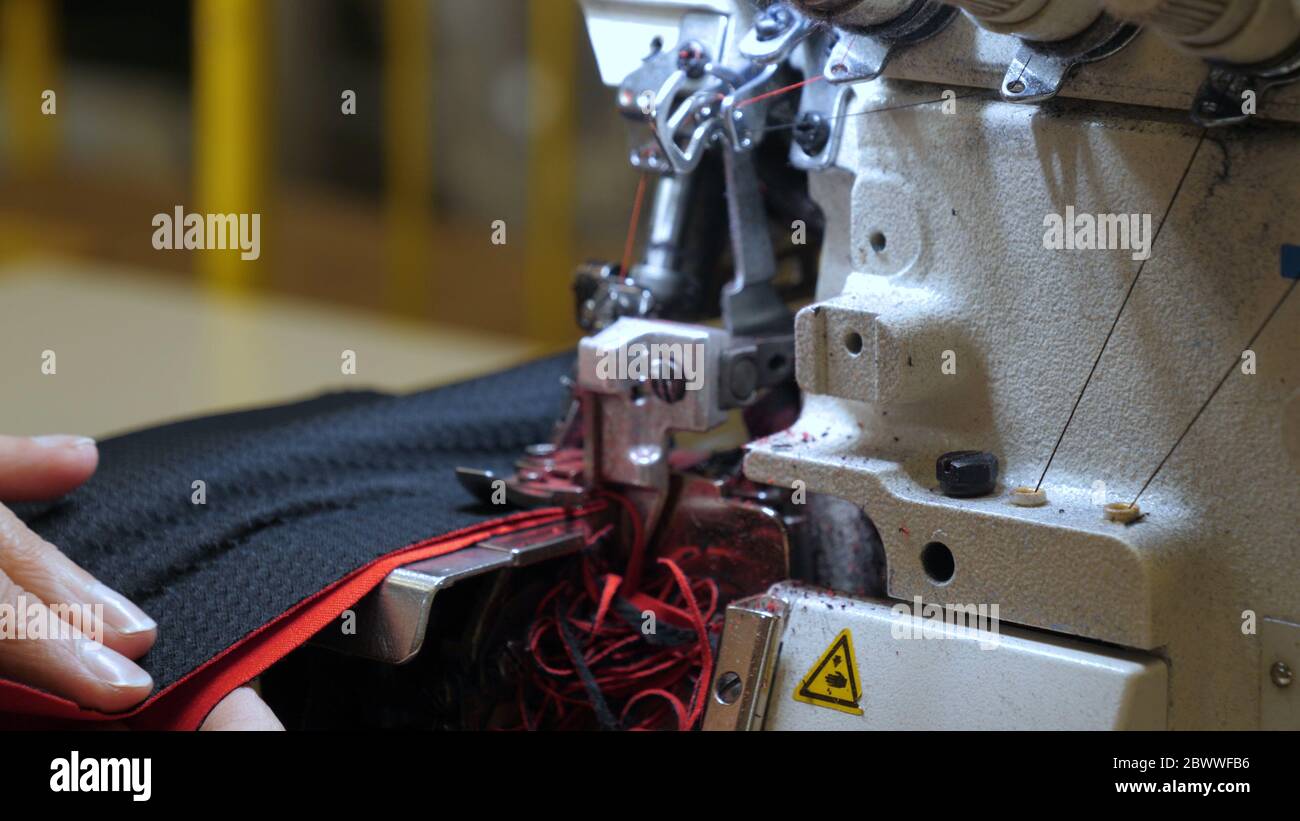 Industrial garment factory, an automatic sewing machine sews various ...