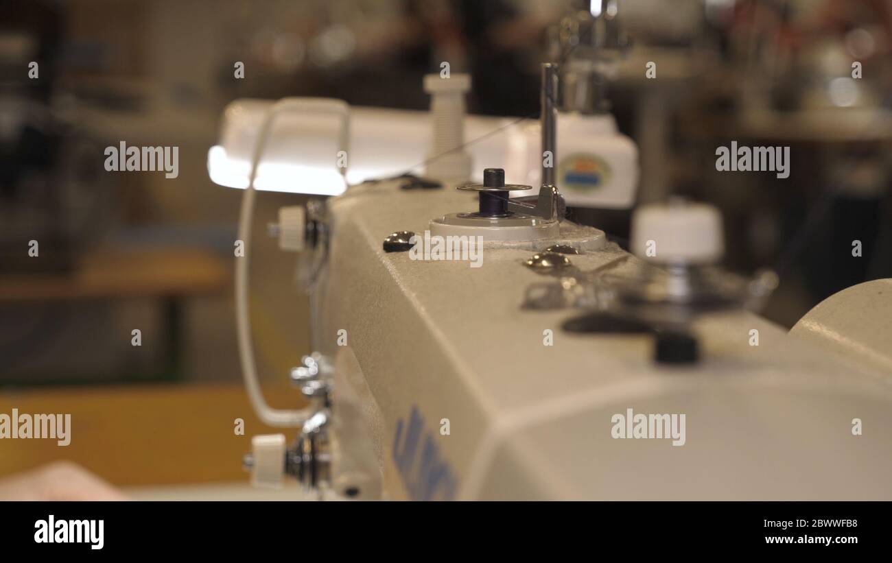 Industrial garment factory, an automatic sewing machine sews various ...